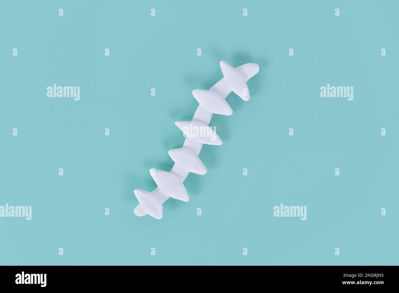 Simple human spine model on blue background Stock Photo - Alamy