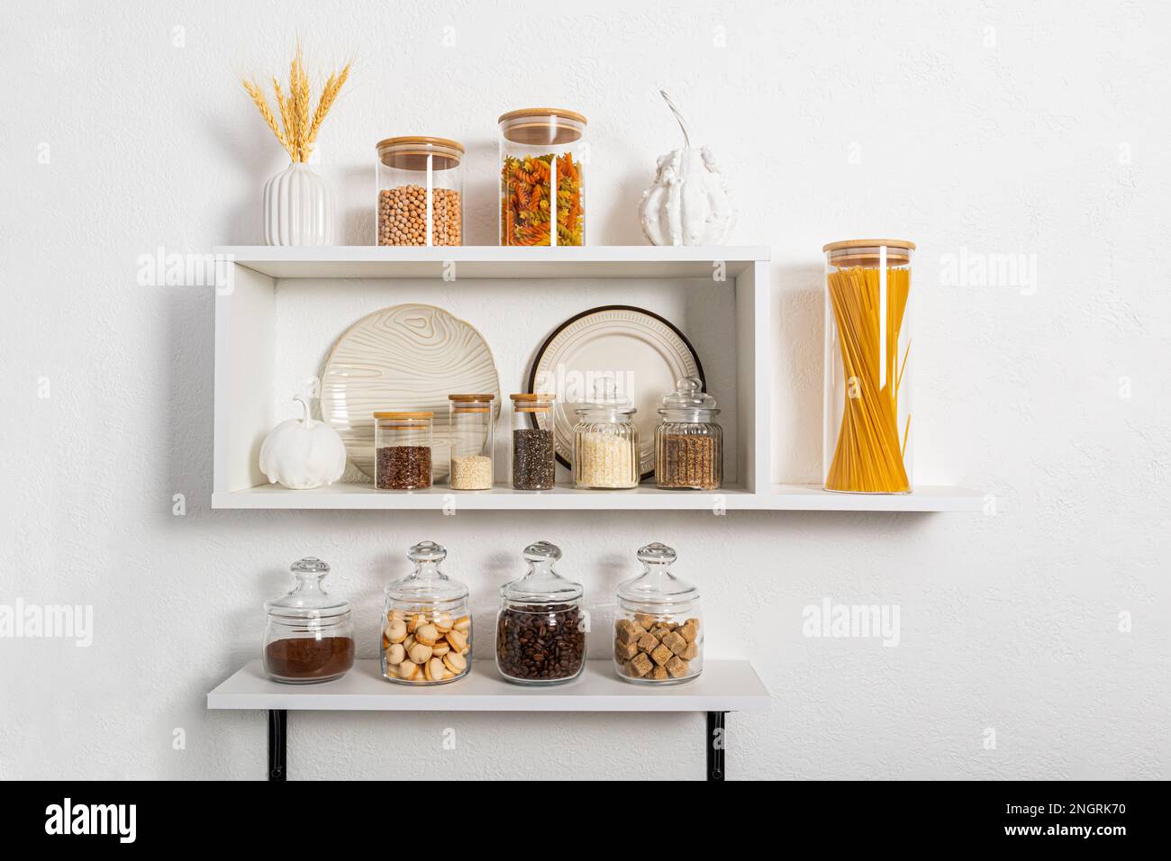 a set of glass and ceramic dishes, glass filled jars with bulk products ...