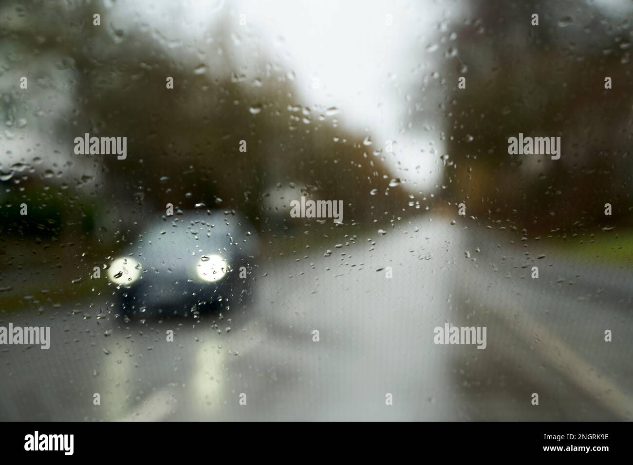 Road in heavy rain. Water falling or raining in front of the car on the ...
