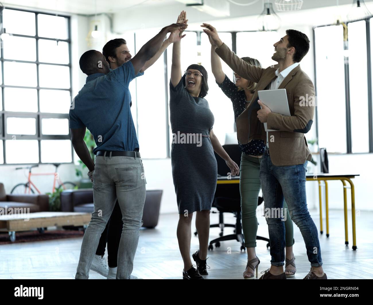 Teamwork, happy and celebration with business people in office and ...