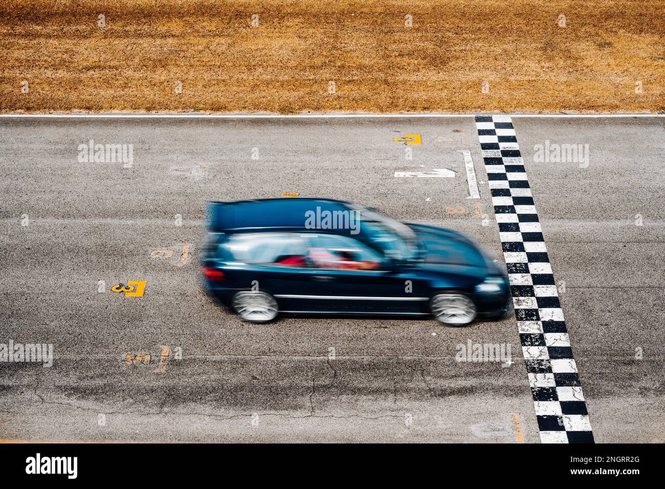 Car race on the international race track crossing finish line with ...