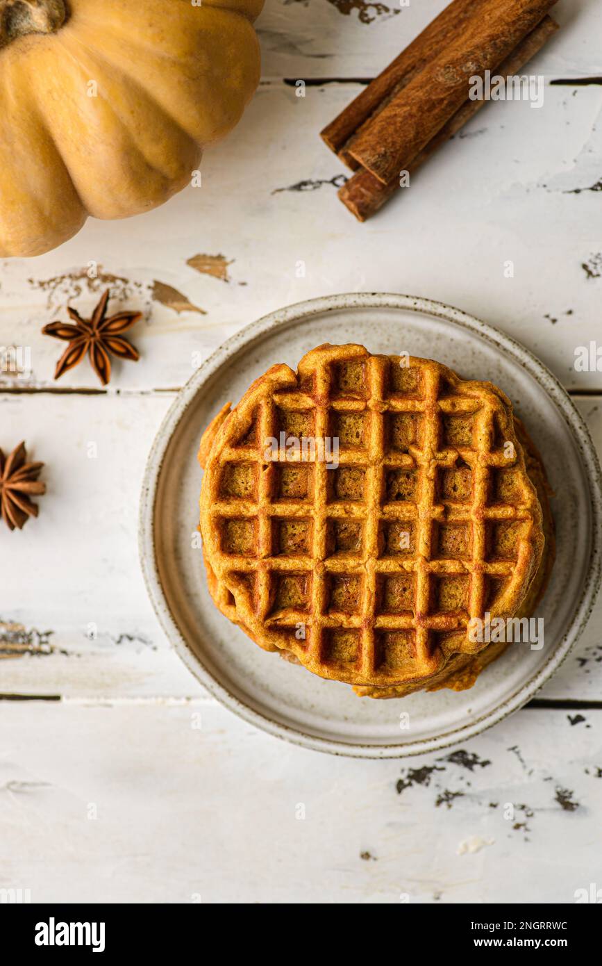 pumpkin waffles on a white wooden background. waffles made from pumpkin ...