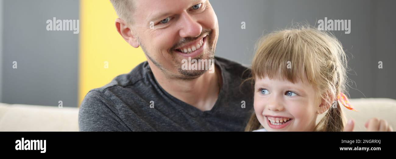 Happy dad holding cute cheerful daughter laughing and having good time ...