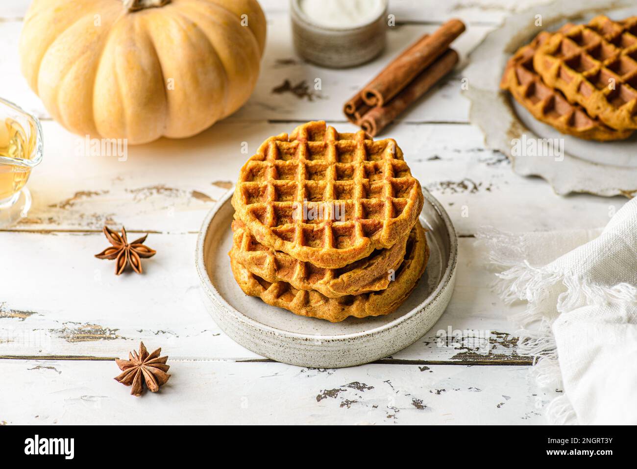 pumpkin waffles on a white wooden background. waffles made from pumpkin ...