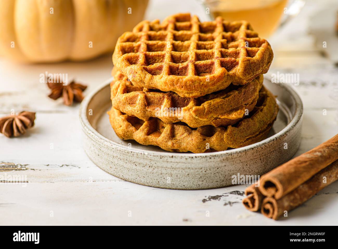 pumpkin waffles on a white wooden background. waffles made from pumpkin ...