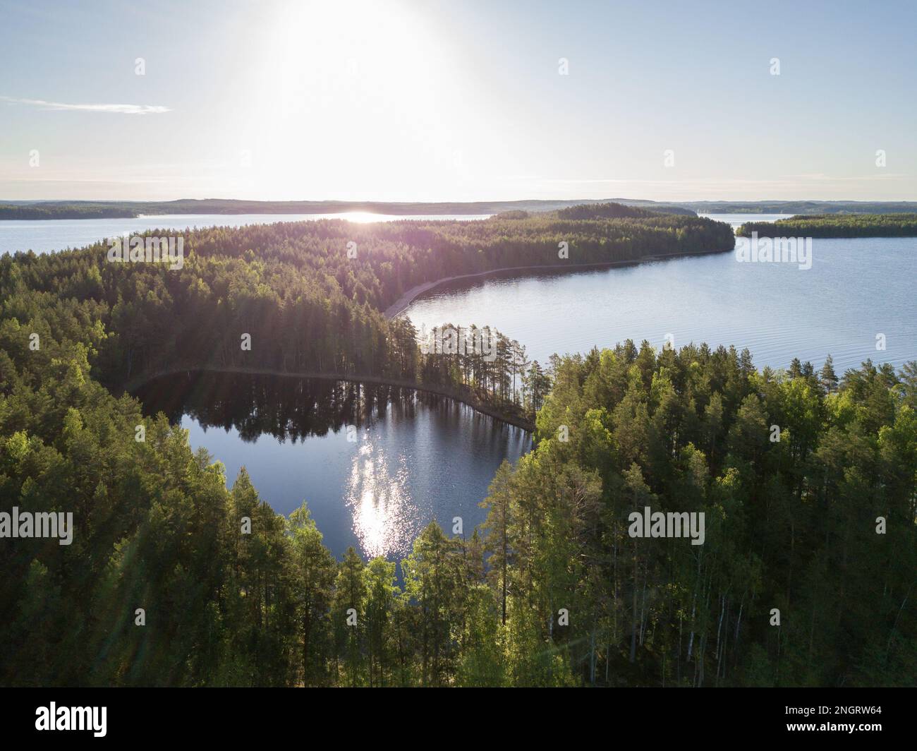 Sun reflecting from lake surface at ridge island Stock Photo - Alamy