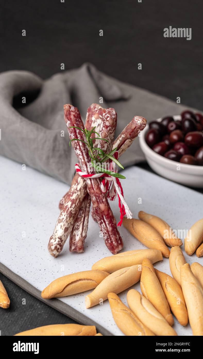 Spanish mini fuet, olives and picos Stock Photo - Alamy