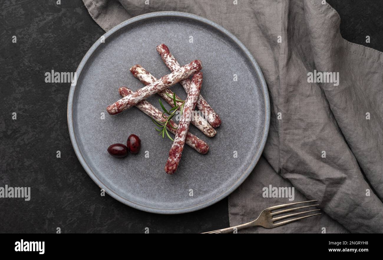 Spanish mini fuet on the grey plate Stock Photo - Alamy