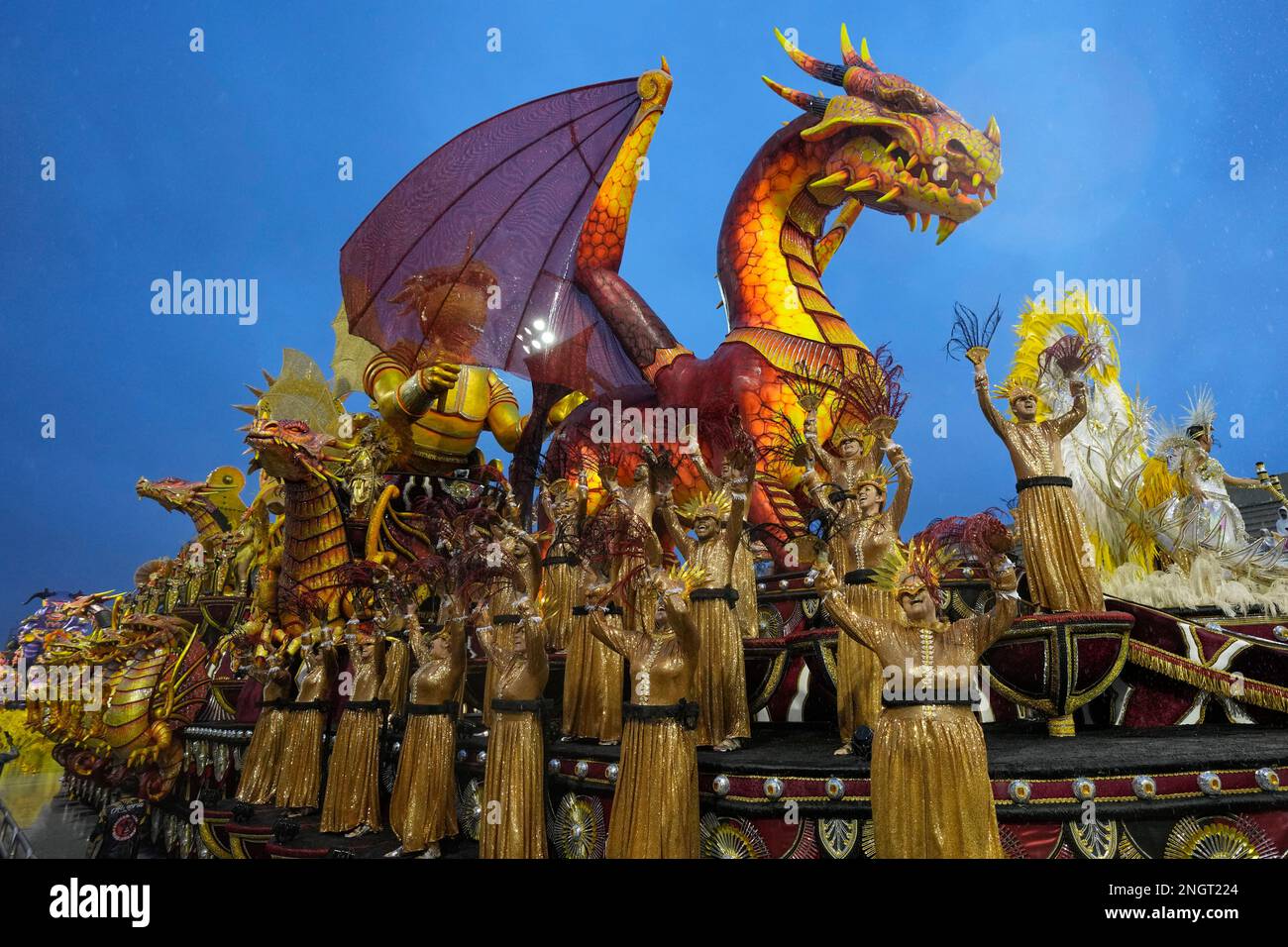 Dancers from the Dragoes da Real samba school perform on a float during ...