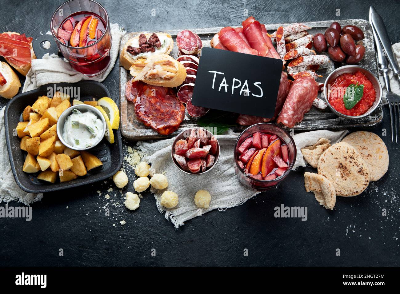 Typical spanish tapas with jamon slices, chorizo, salami, olives ...