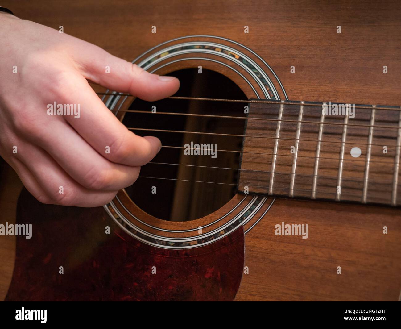 Practice playing the acoustic guitar. Hands playing guitar and picking ...
