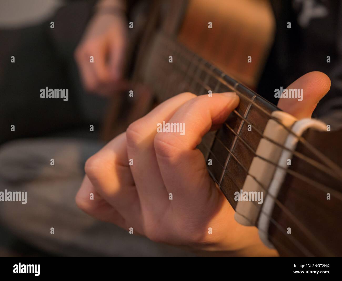 Practice playing the acoustic guitar. Hands playing guitar and picking ...