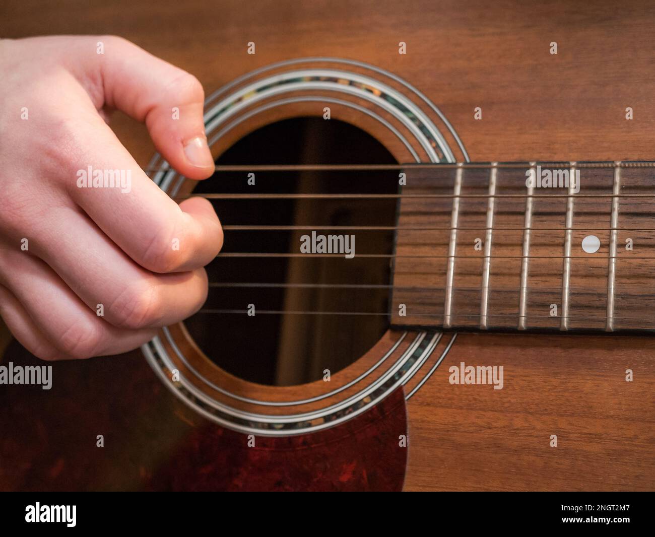 Practice playing the acoustic guitar. Hands playing guitar and picking ...