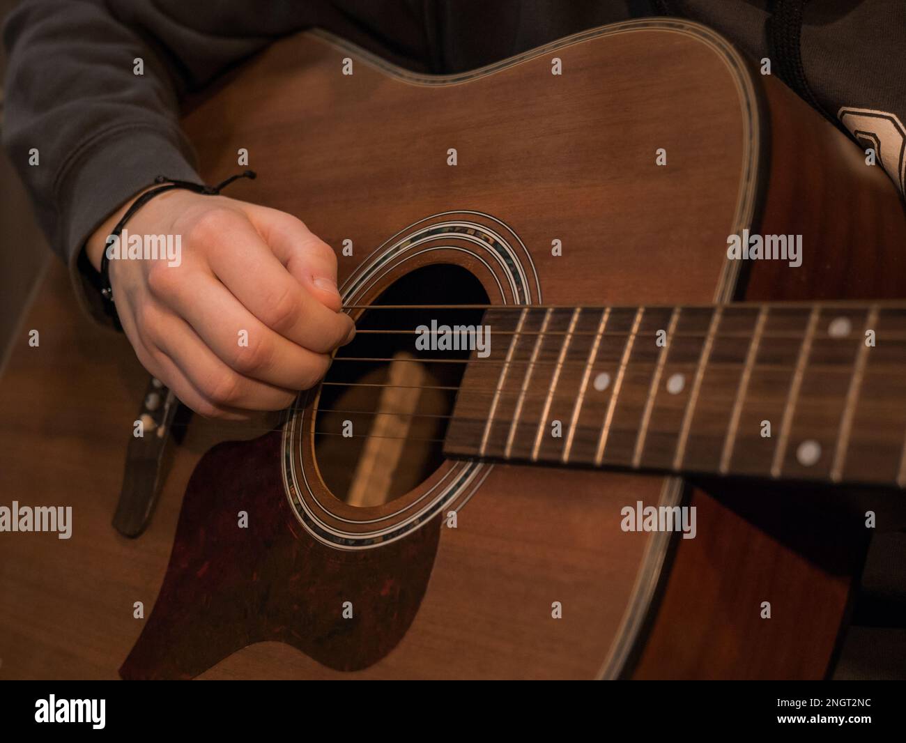 Practice playing the acoustic guitar. Hands playing guitar and picking ...