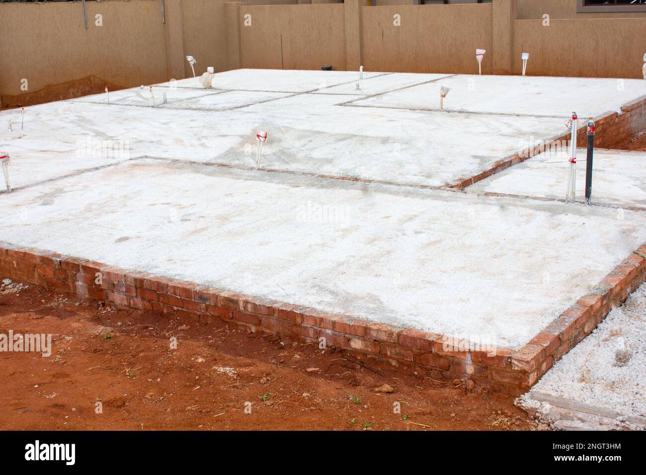 Concrete foundation slabs of a new building supported by brick walls ...
