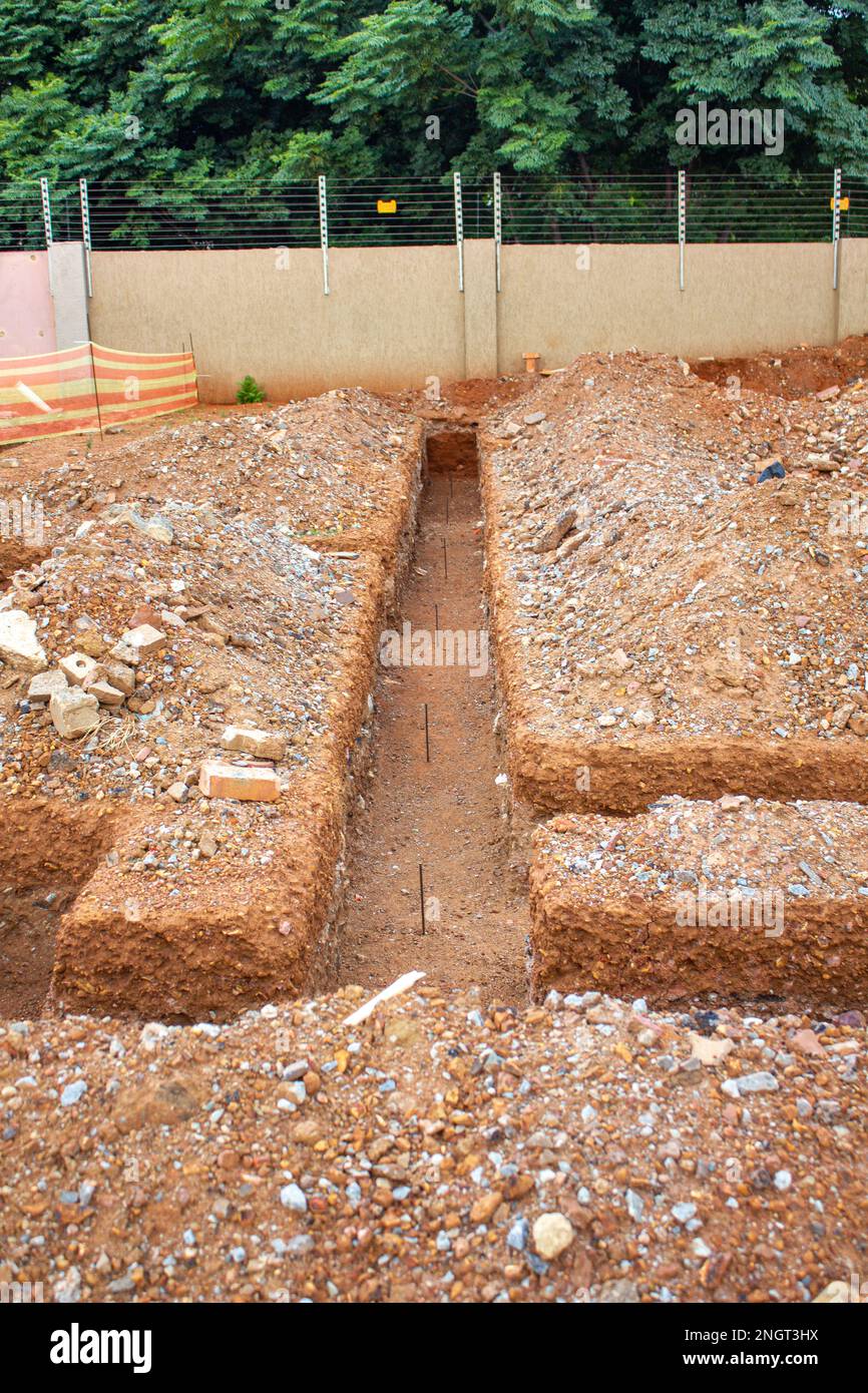 Selective focus on newly dug foundations of a building before concrete ...