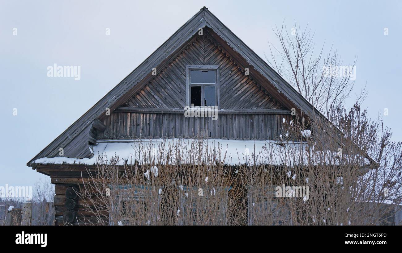upper part of a wooden house with a broken window winter Stock Photo ...