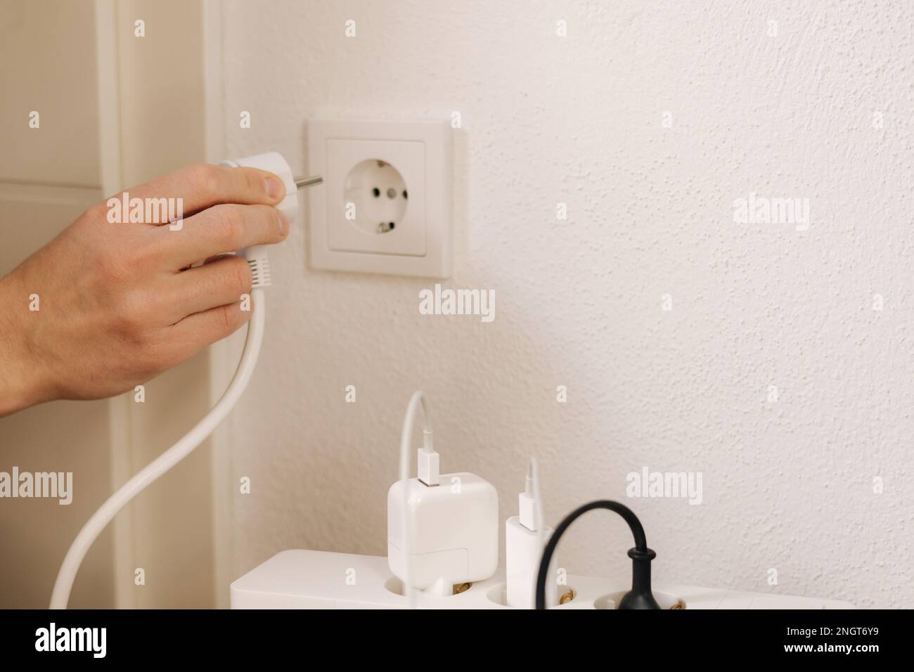 The extension cord filled with chargers is connected to a 220V outlet ...