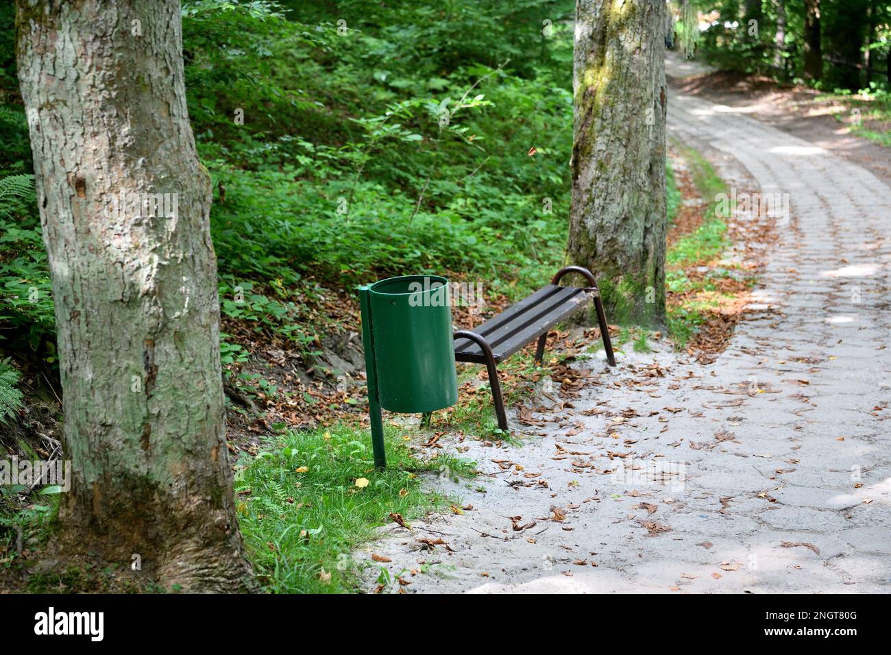 A metal waste bin on a hiking trail in a park for people Stock Photo ...