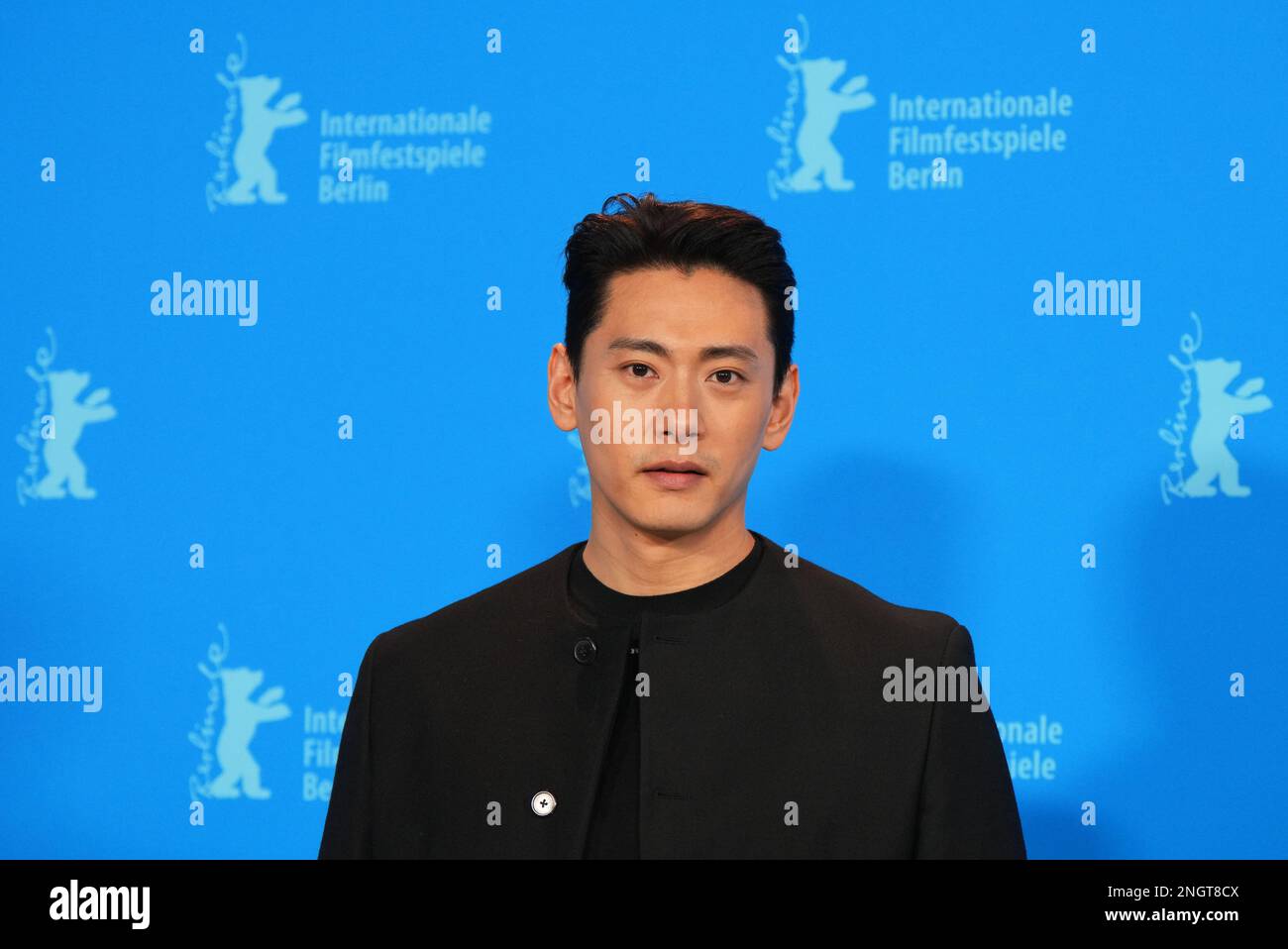 Berlin, Germany. 19th Feb, 2023. Teo Yoo, actor, stands in front of the ...