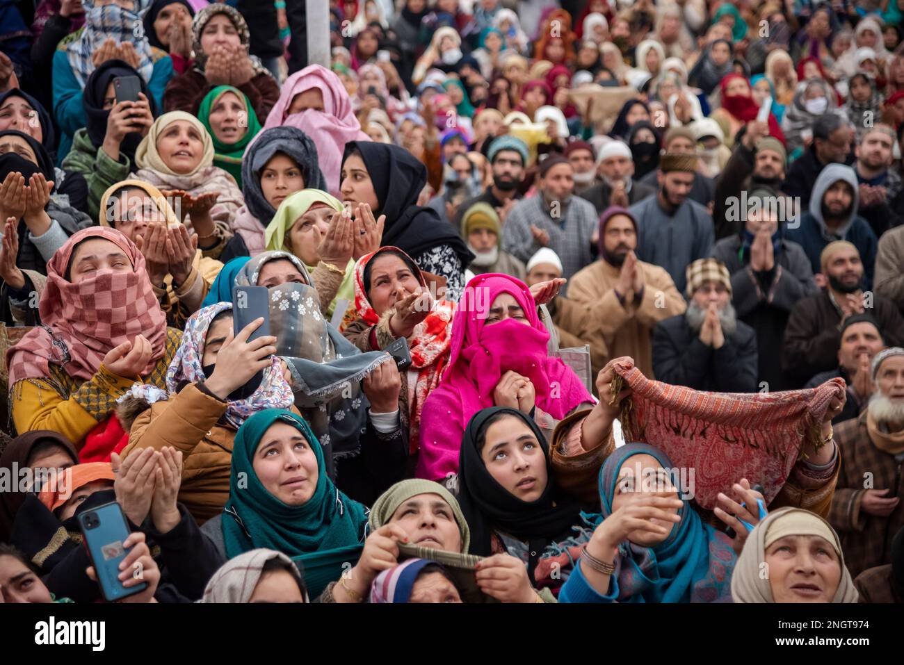 Muslim devotees cry while praying as the head priest displays the holy ...