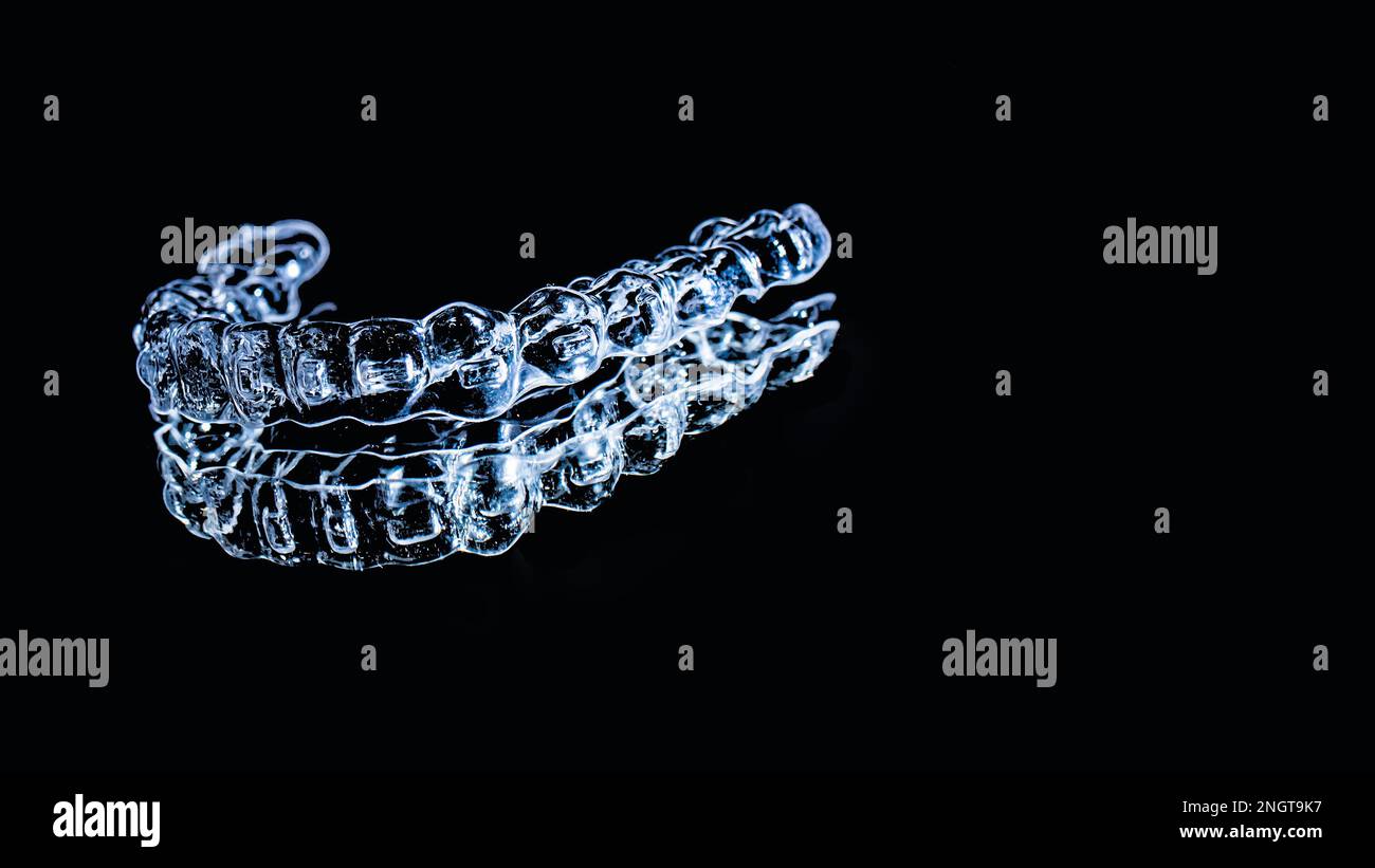 Invisible aligner teeth retainers lie on the mirror in orthodontic ...