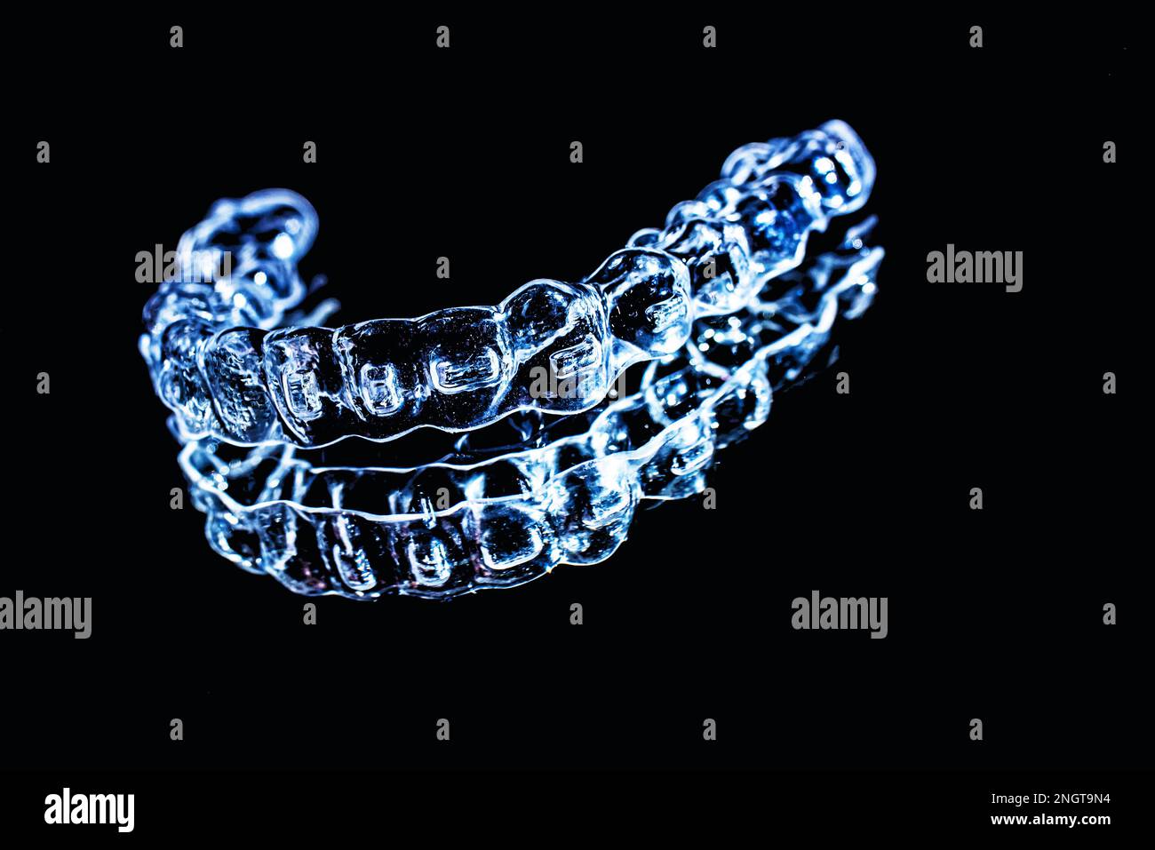 Invisible aligner teeth retainers lie on the mirror in orthodontic ...