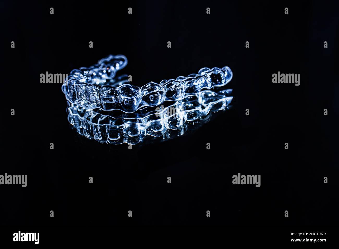 Invisible aligner teeth retainers lie on the mirror in orthodontic ...