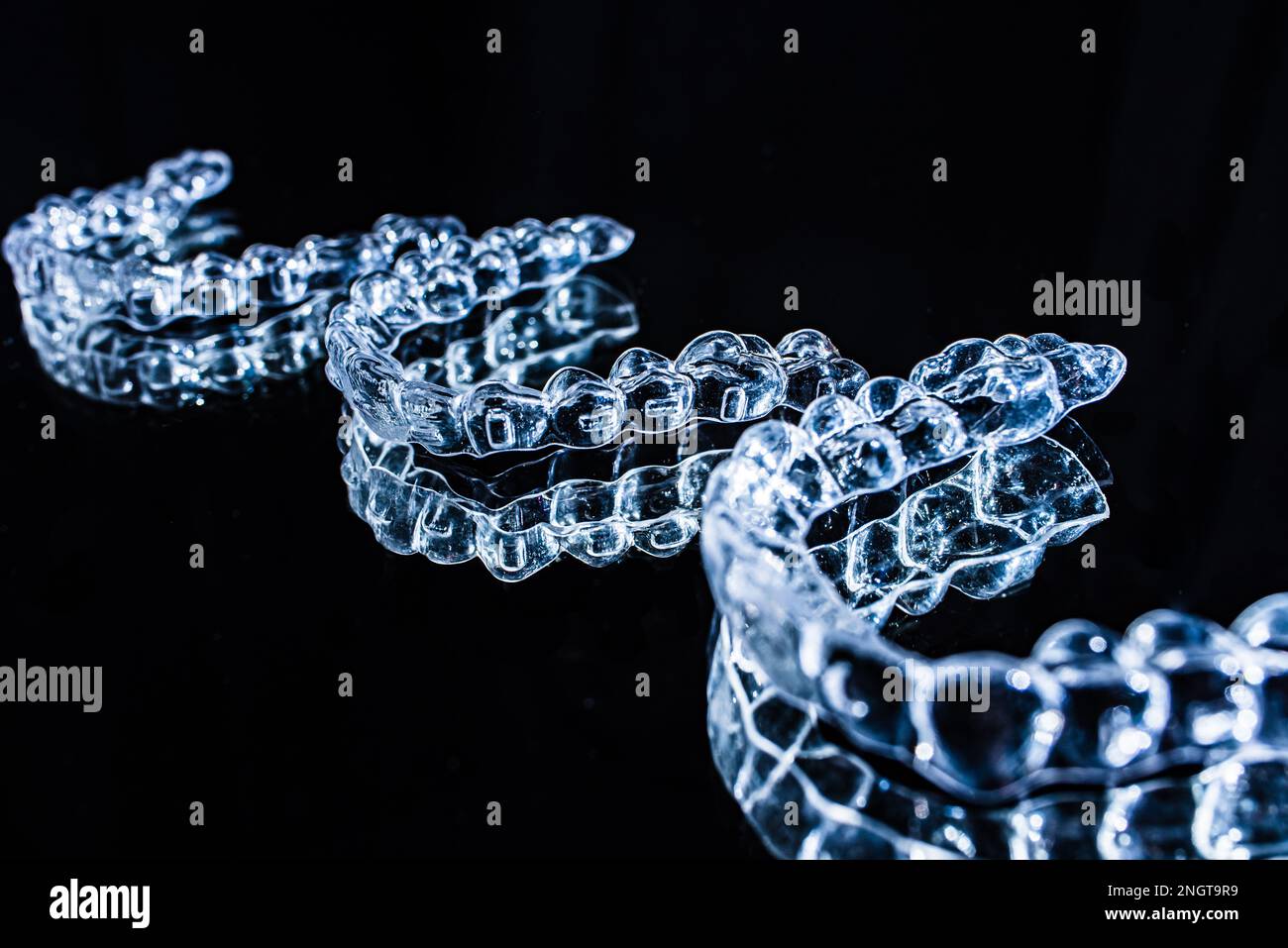 Invisible aligner teeth retainers lie on the mirror in orthodontic ...