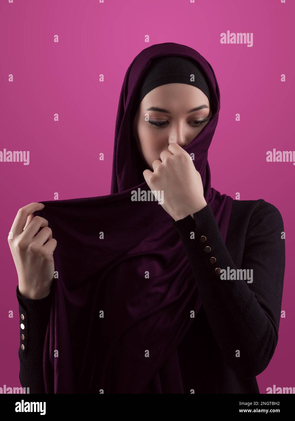 Modern Muslim woman wearing stylish hijab casual wear isolated on pink ...