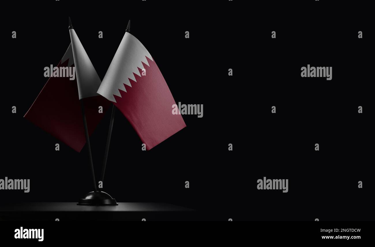 Small national flags of the Qatar on a black background Stock Photo - Alamy
