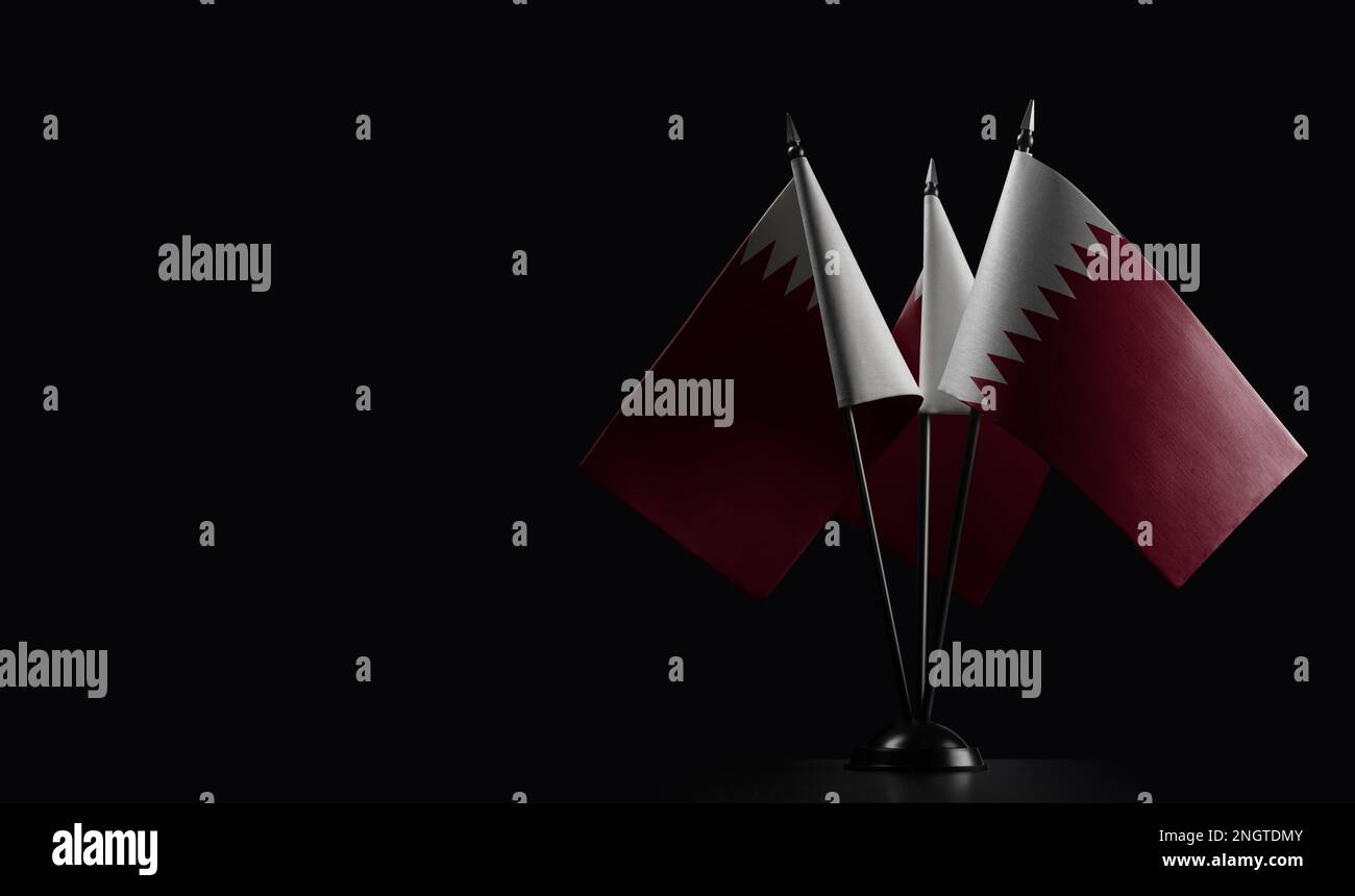 Small national flags of the Qatar on a black background Stock Photo - Alamy