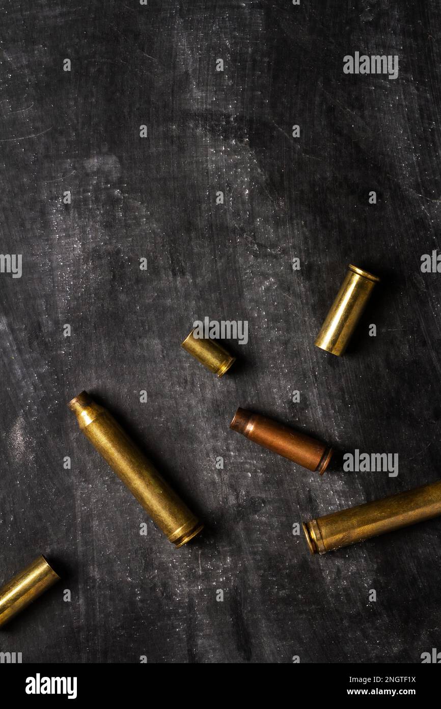 Empty bullet cartridges lying on the black background Stock Photo - Alamy