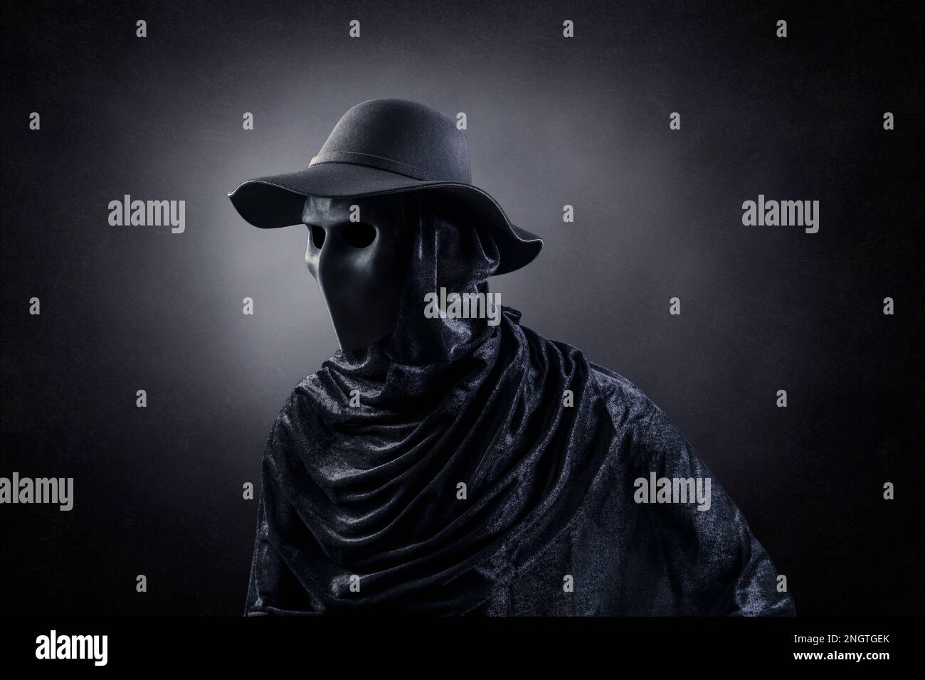 Creepy figure with old hat over dark misty background Stock Photo - Alamy
