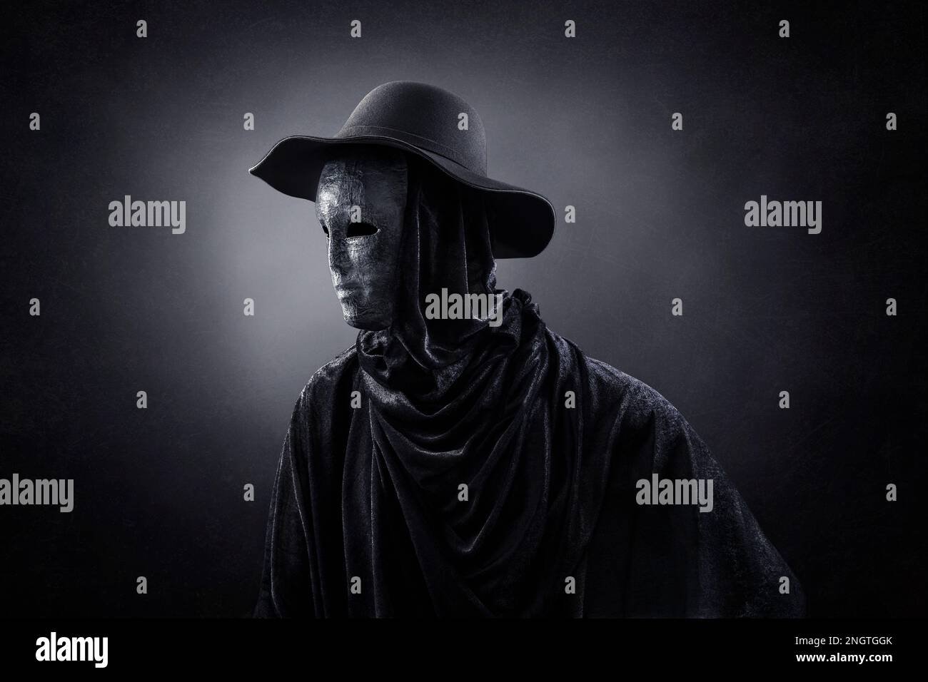 Creepy figure with old hat over dark misty background Stock Photo - Alamy