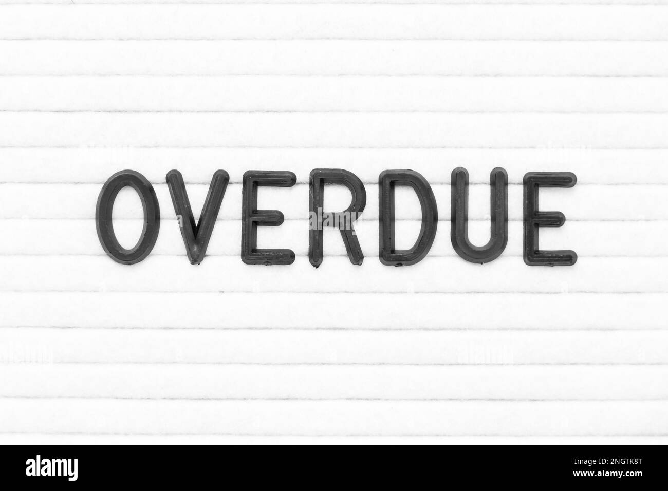 Black color letter in word overdue on white felt board background Stock ...
