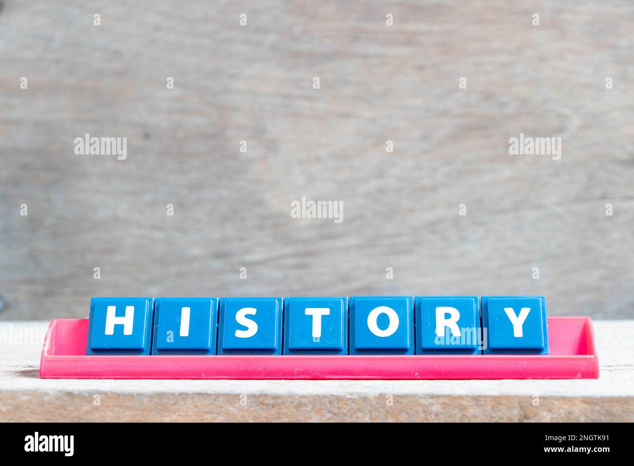Tile alphabet letter with word history in red color rack on wood ...