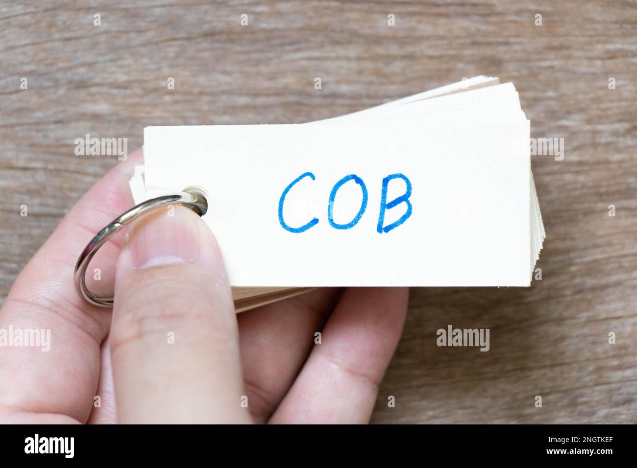 Hand hold flash card with handwriting in word COB (abbreviation of ...