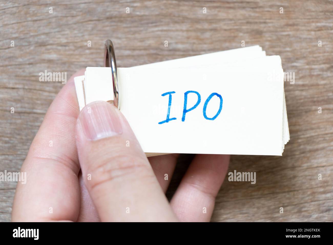 Hand hold flash card with handwriting in word IPO (Abbreviation of ...