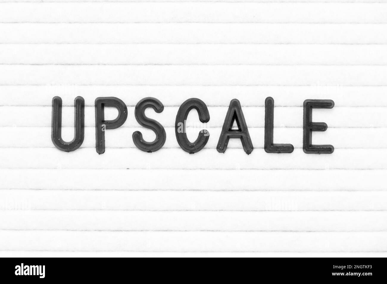 Black color letter in word upscale on white felt board background Stock ...