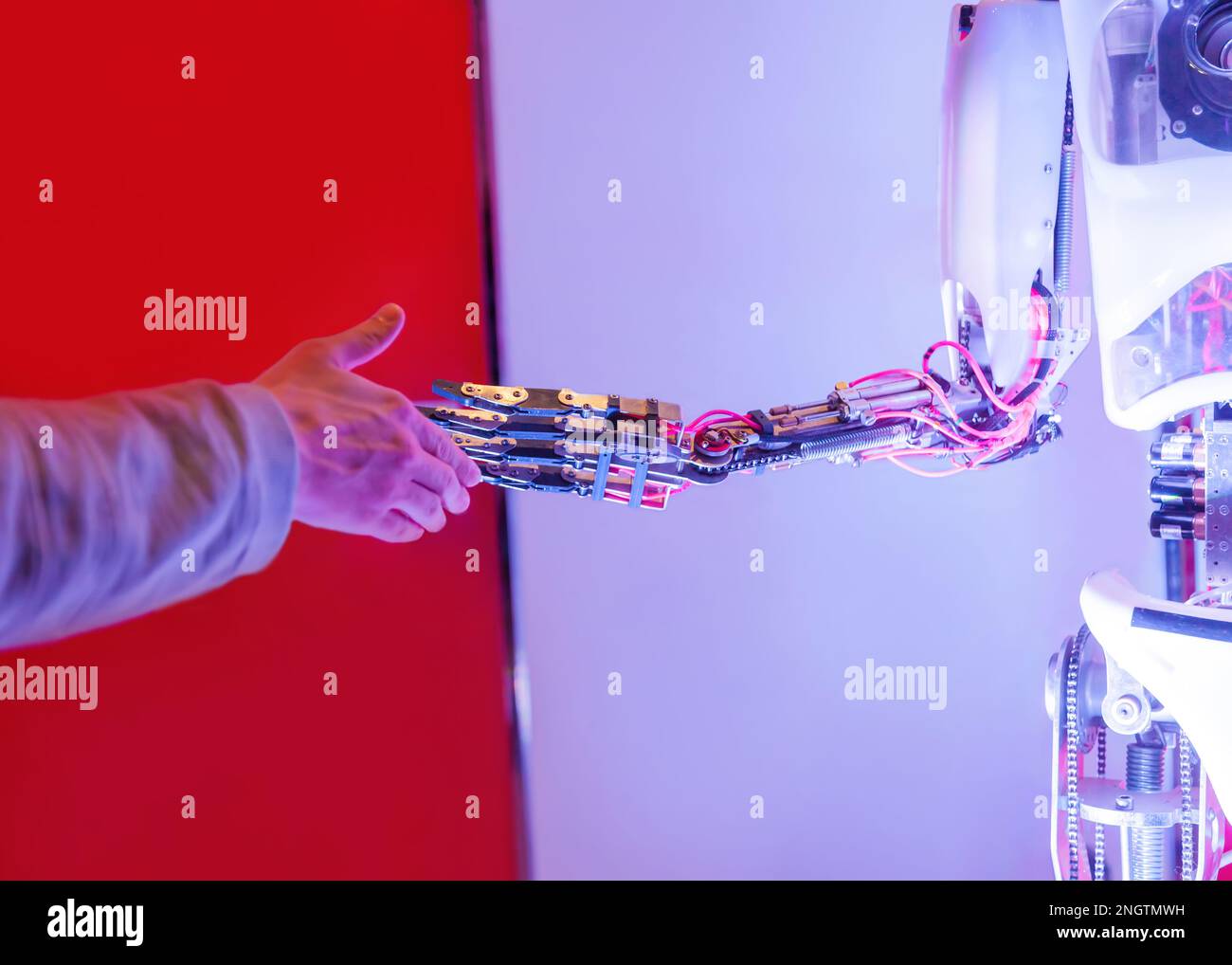 Man gives his hand to shake it to robot. The interaction of humans and artificial intelligence ...