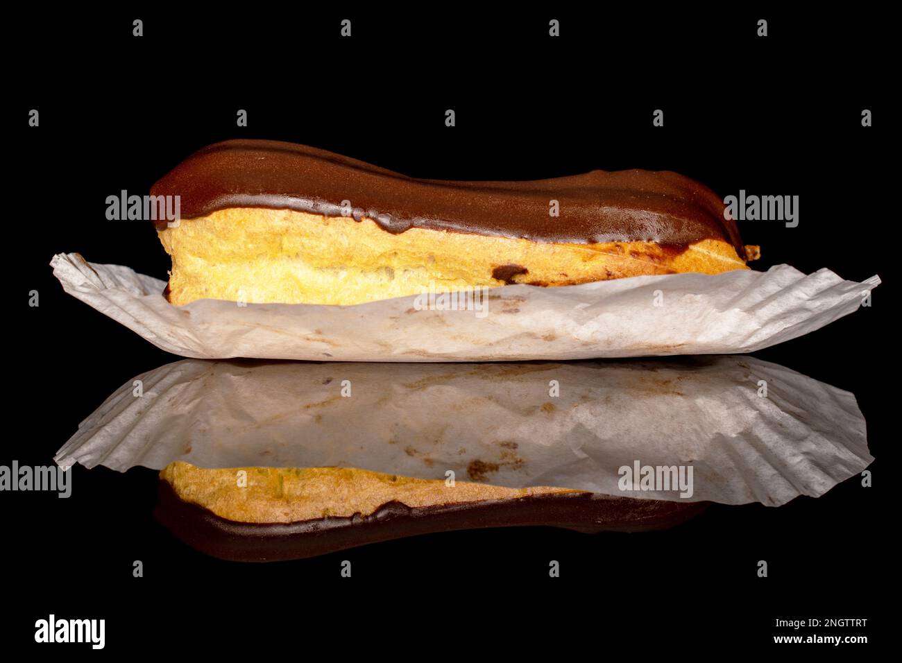 One chocolate eclair, macro, isolated on black background Stock Photo ...
