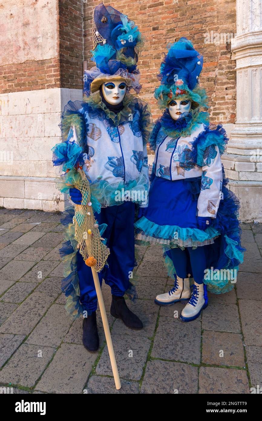 Carnival goers dressed in splendid costumes and masks during Venice ...