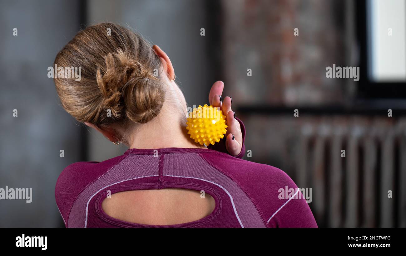 The athlete does a relaxing massage of the neck and back with the help ...