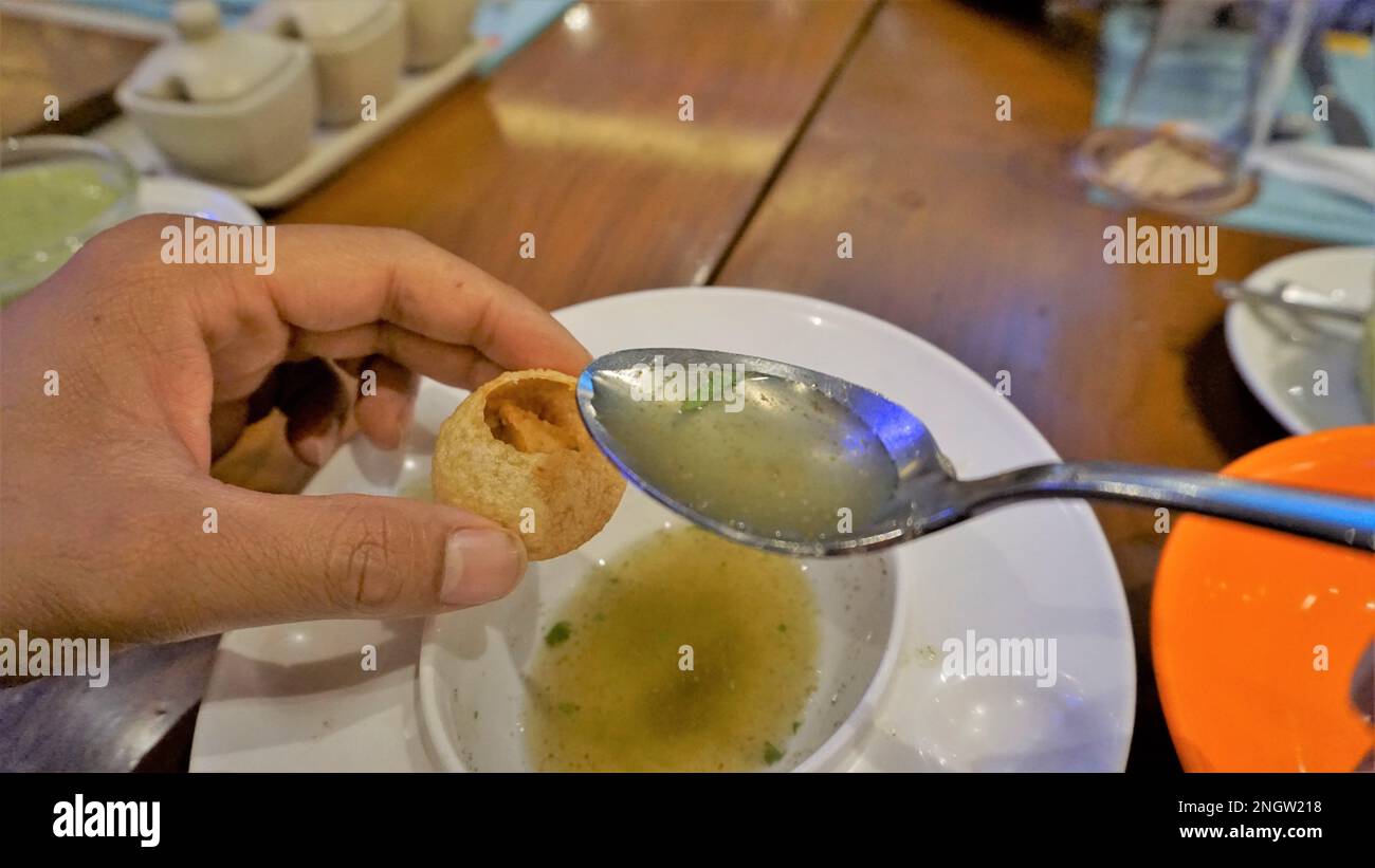 Indian man holding Panipuri or Golgappa or Puchkas with potato masala ...