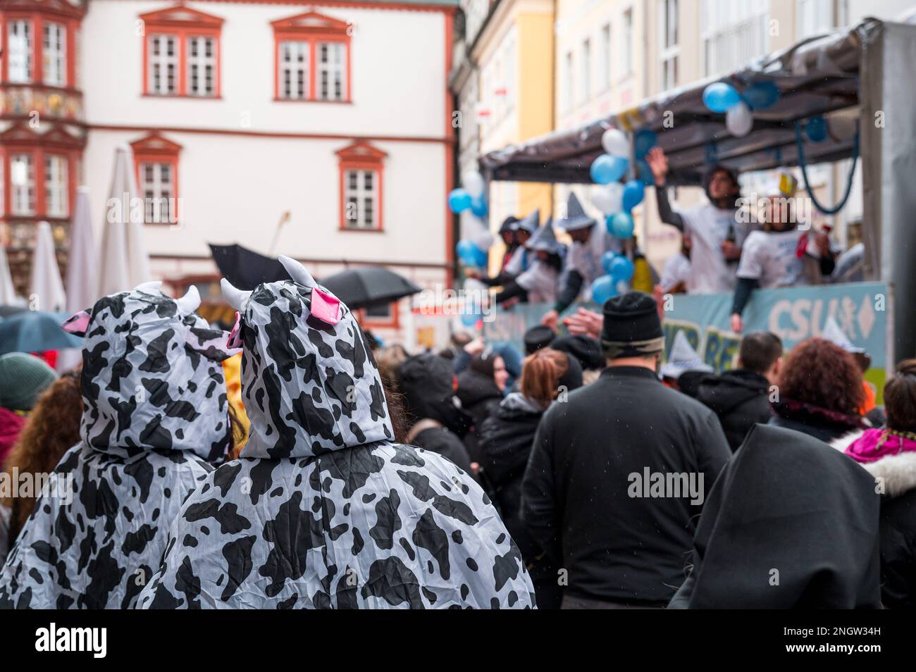 Coburg, Germany. 19th Feb, 2023. Two fools dressed as cows watch the ...
