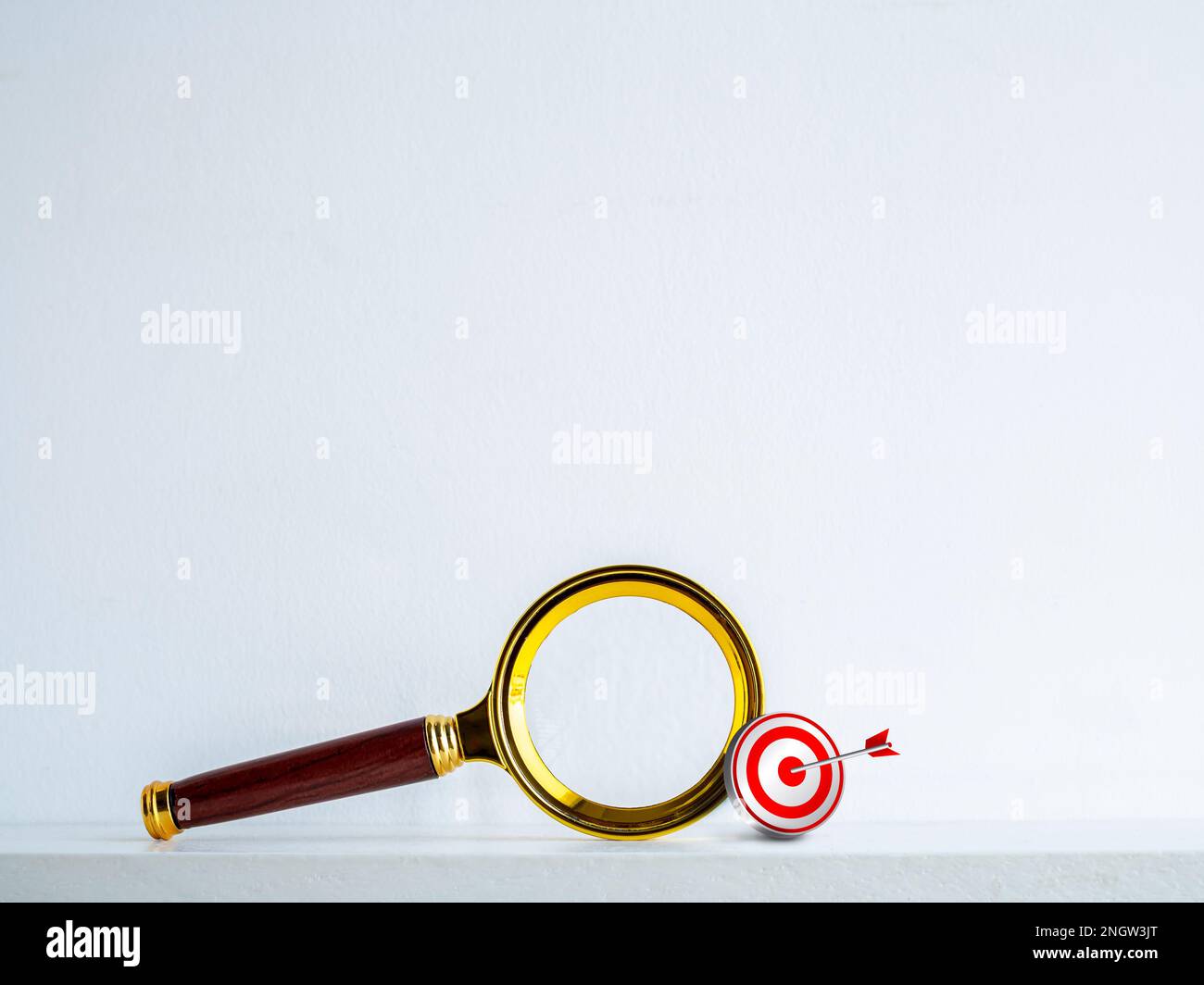 3D target icon and empty gold magnifying glass with wood handle on ...