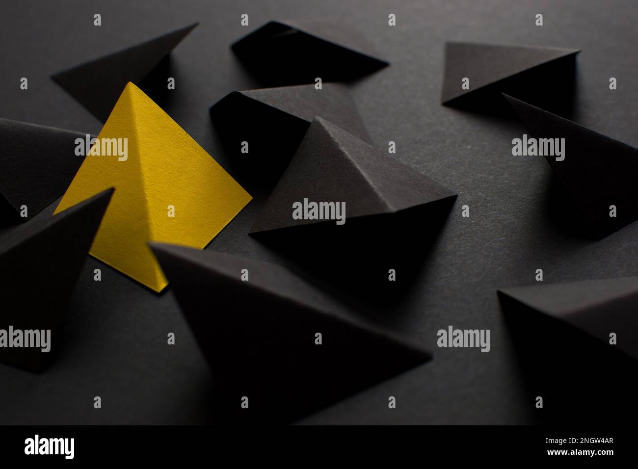 Yellow and black folded paper background. Different ways of thinking ...