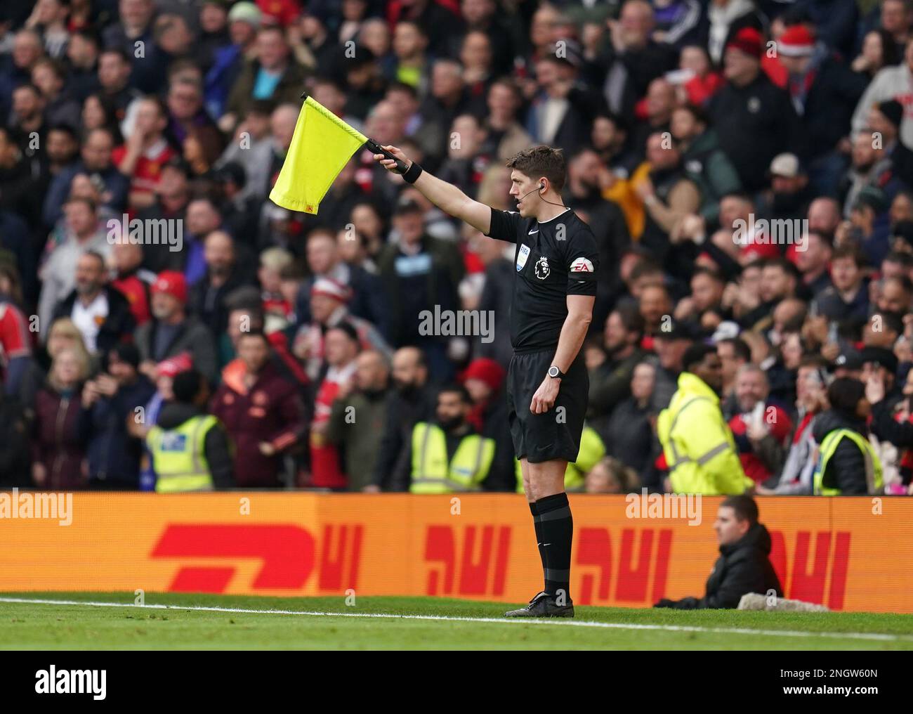 The linesman holds up an offside flag following Manchester United's ...
