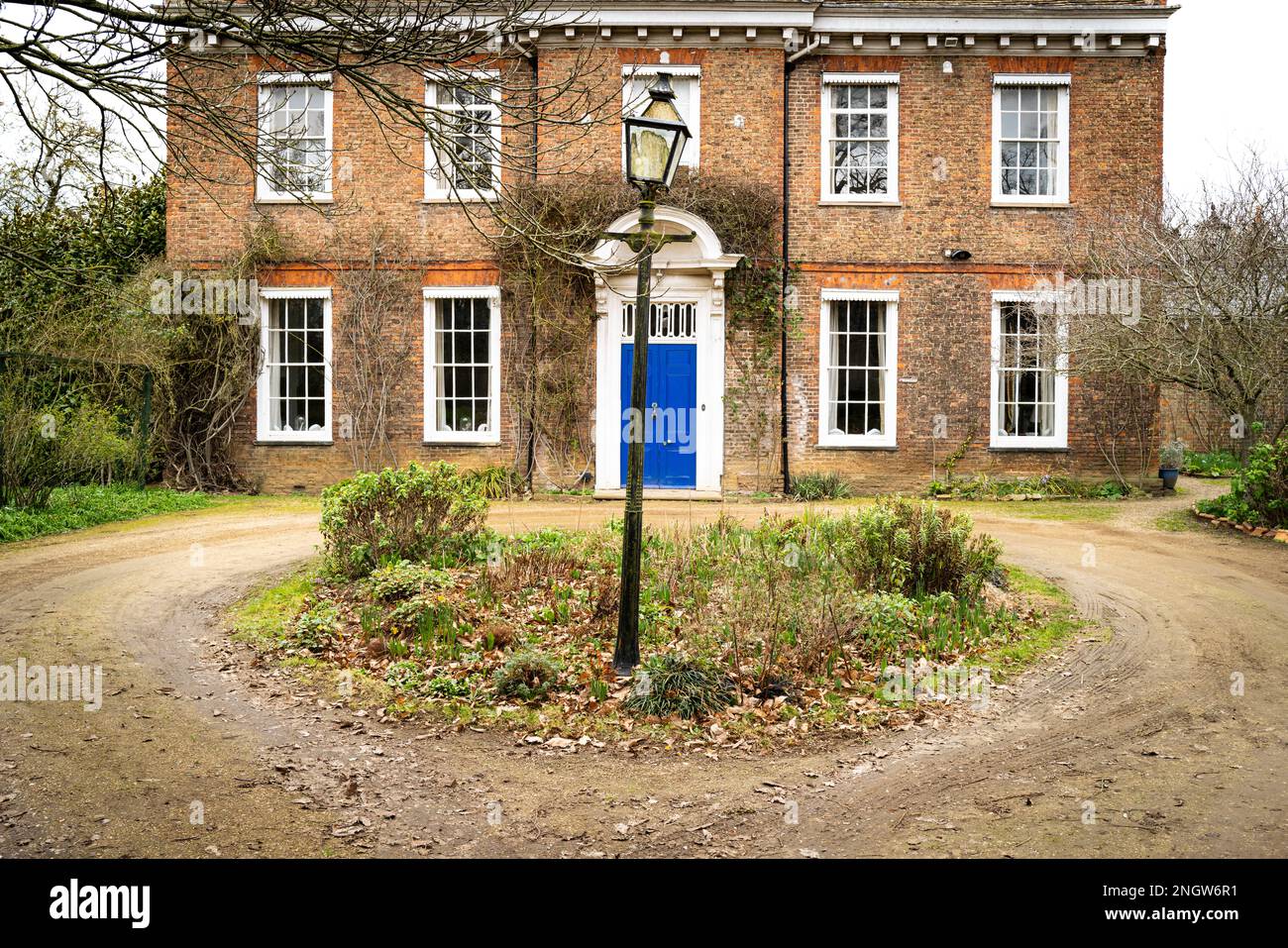 Front aspect view of an old Manor House showing a circular driveway and ...